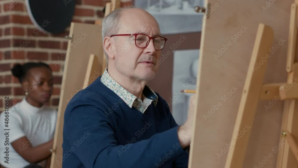 Senior art student creating professional drawing at workshop practice ...