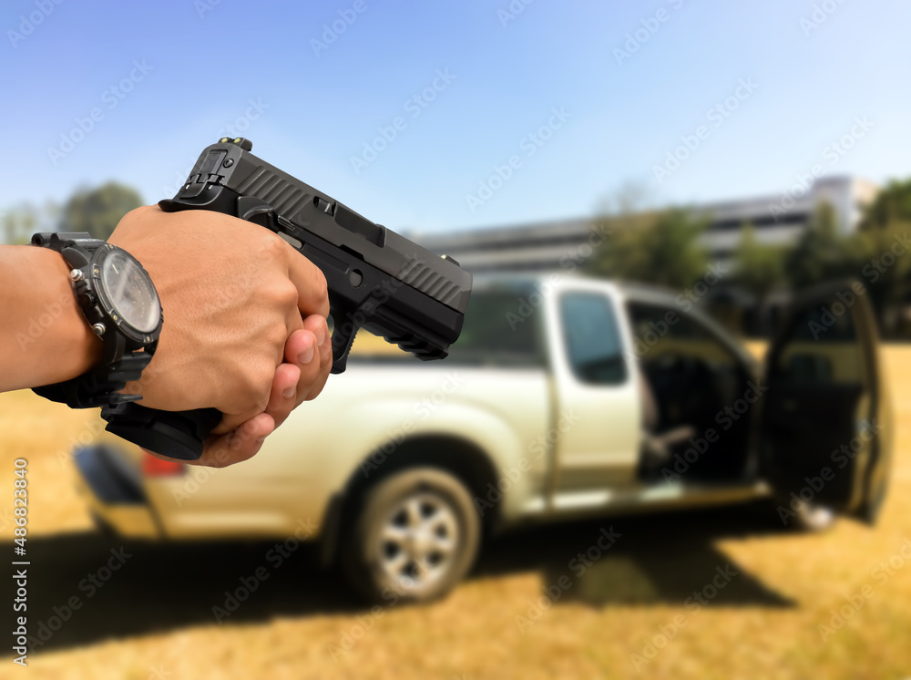 Semi-automatic black 9mm pistol gun holding in hands of gun shooter ...