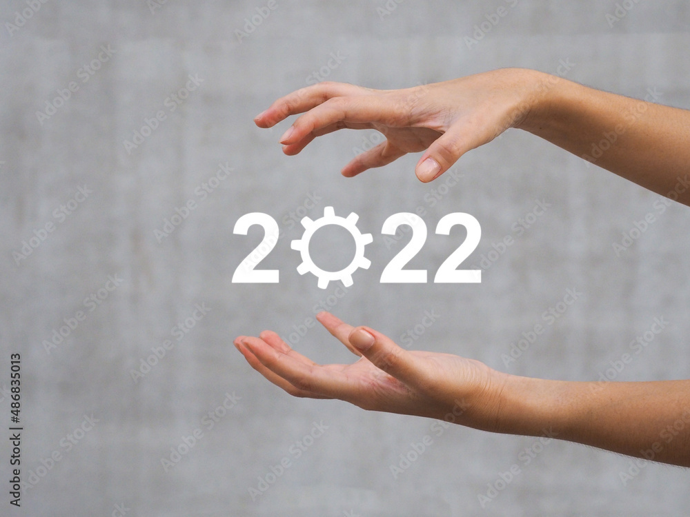 Girl's hand showing 2022 message, zero cog. start of the year of ...