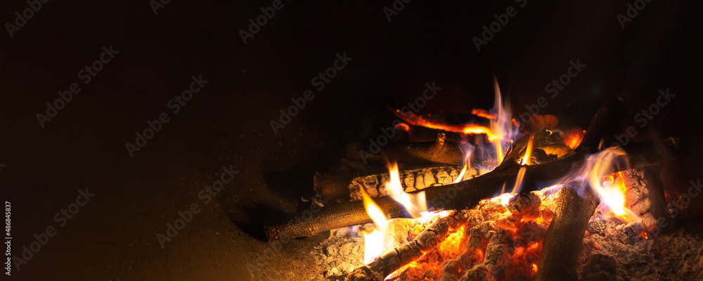 Bonfire, log fire, or campfire in dark background with flame, burned ...
