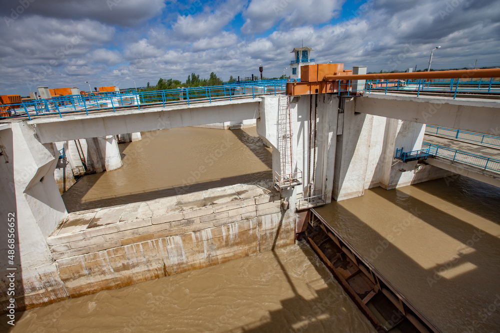 Shardara river dam and bridge. Water shutter down. Orange speed changer ...