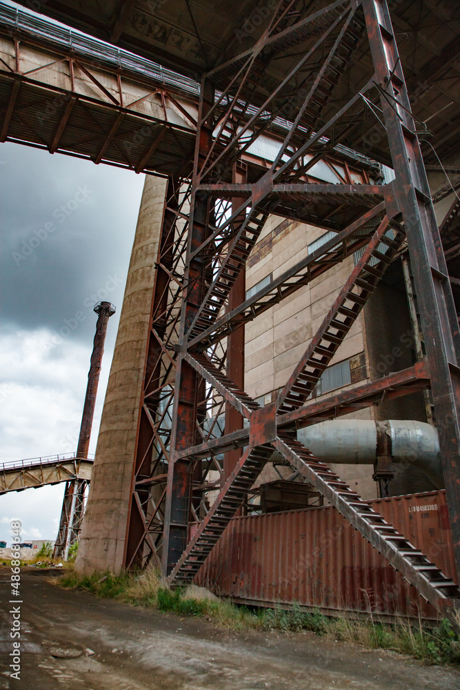 Outdated Soviet cement plant. Metal openwork support of conveyor. Old ...