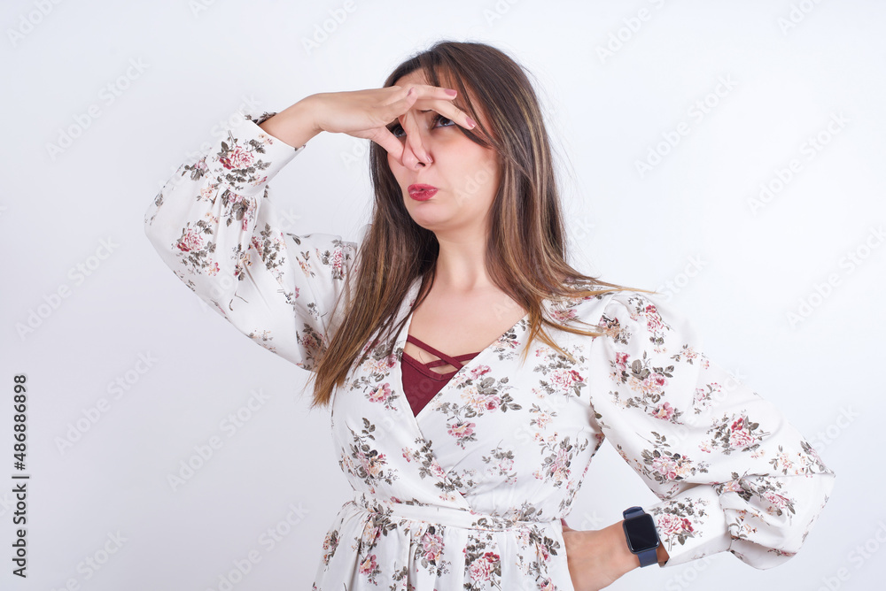 Displeased MODEL plugs nose as smells something stink and unpleasant ...