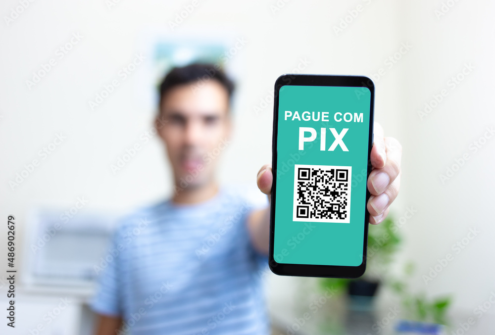 Man holding Smartphone and making payment via PIX. PIX is a new ...