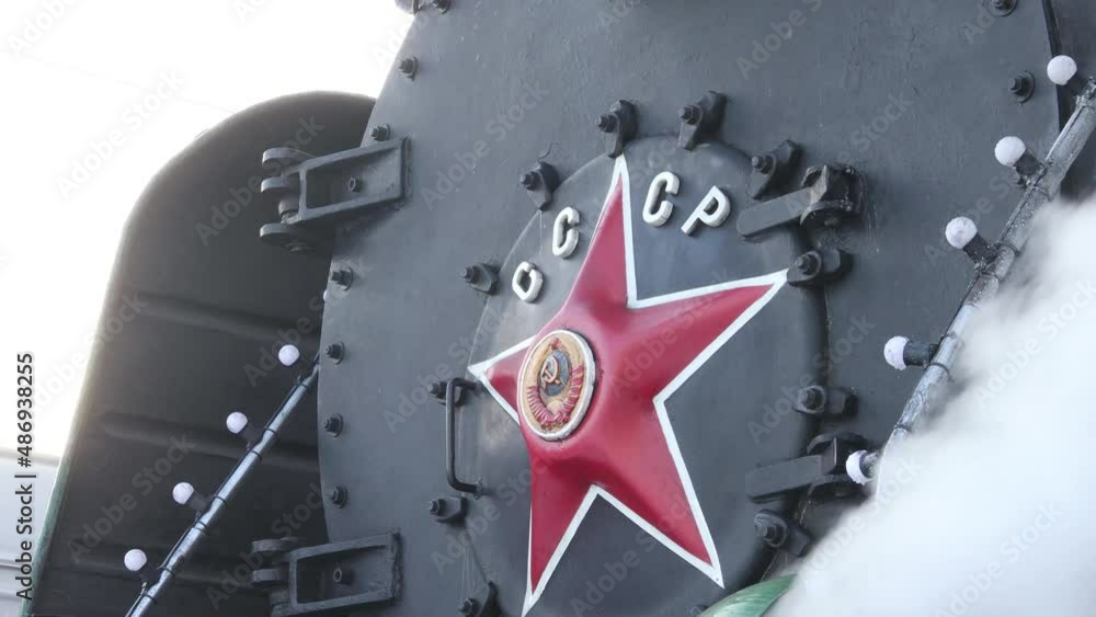 the coat of arms of the USSR on the front of an old steam locomotive of ...