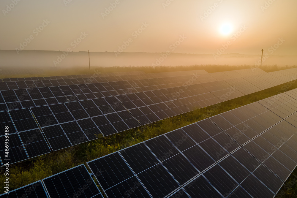 Aerial view of big sustainable electric power plant with many rows of ...