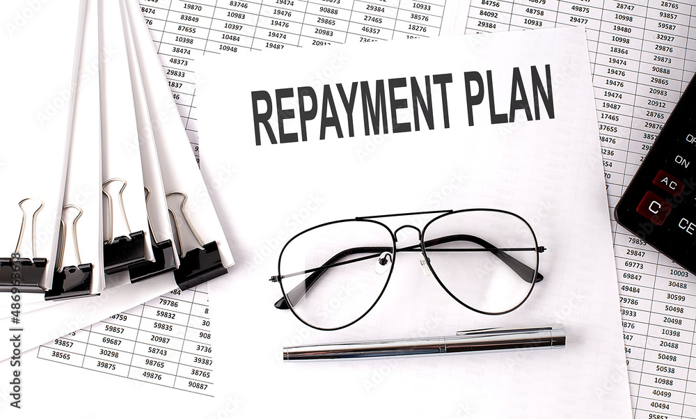 REPAYMENT PLAN text on paper with chart and office tools , business ...