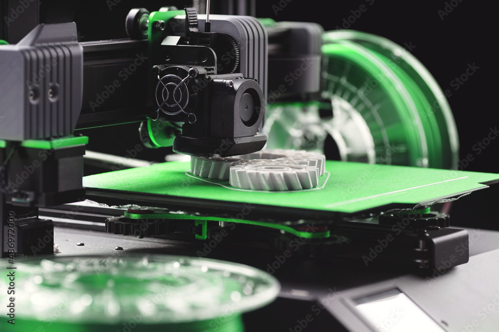 oblique view on FDM-3D-printer with printed parts while manufacturing ...