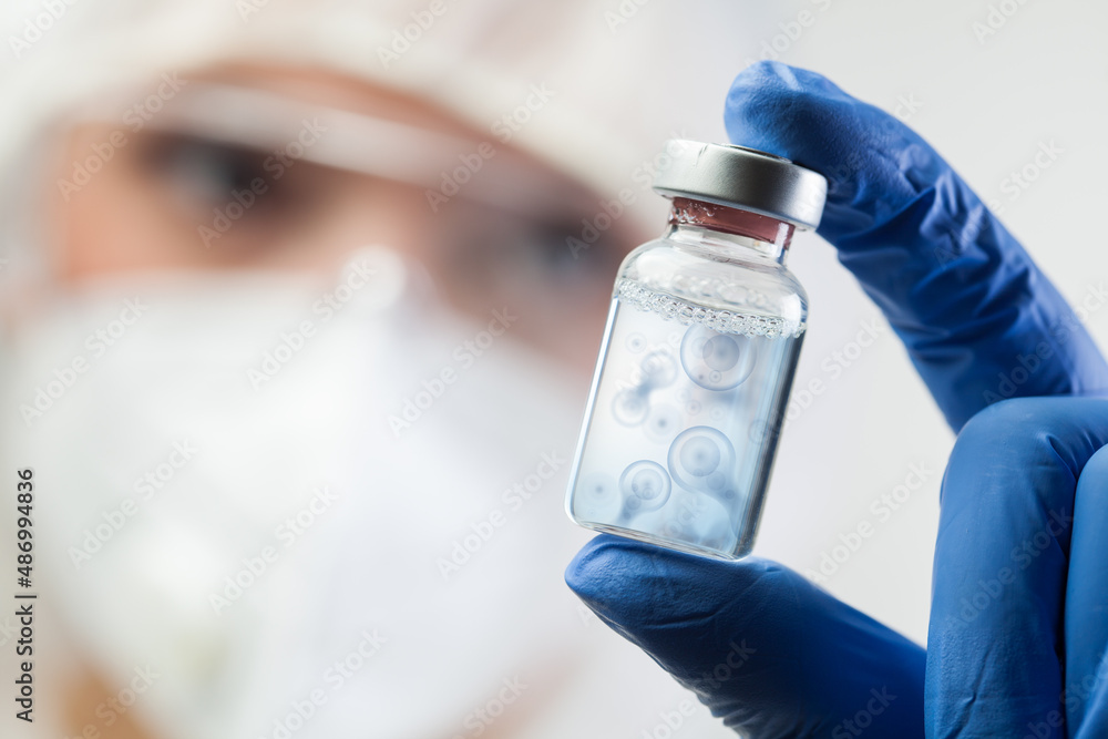 Cell division process conceptual illustration,lab scientist holding ...