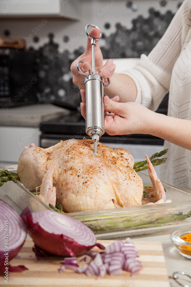 Stainless Steel meat injector being used in kitchen with raw check and ...