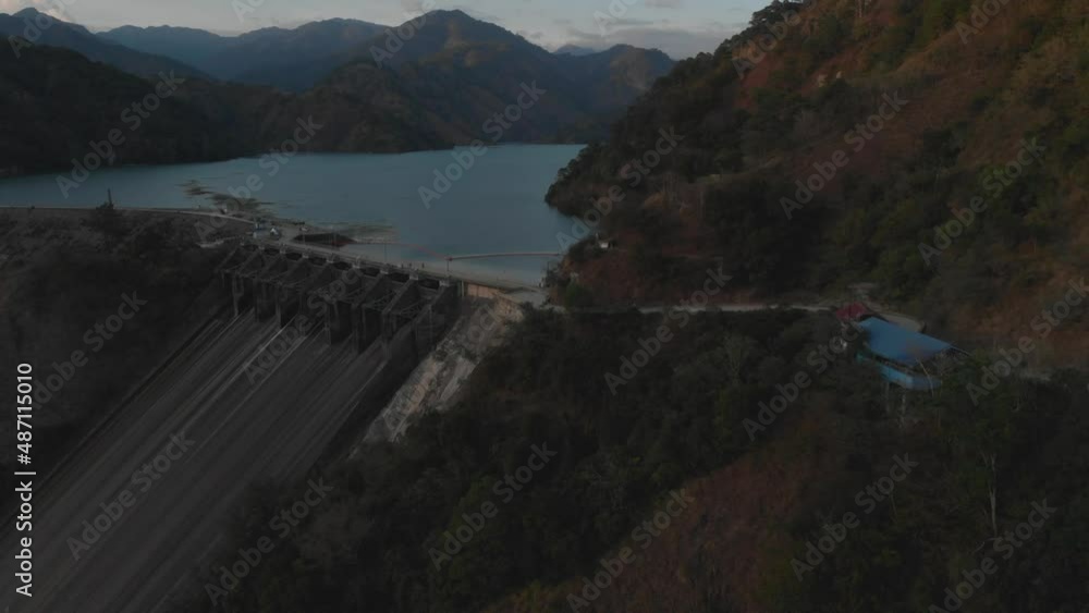 Reverse Aerial of Ambuklao hydroelectric Dam revealing the water ...