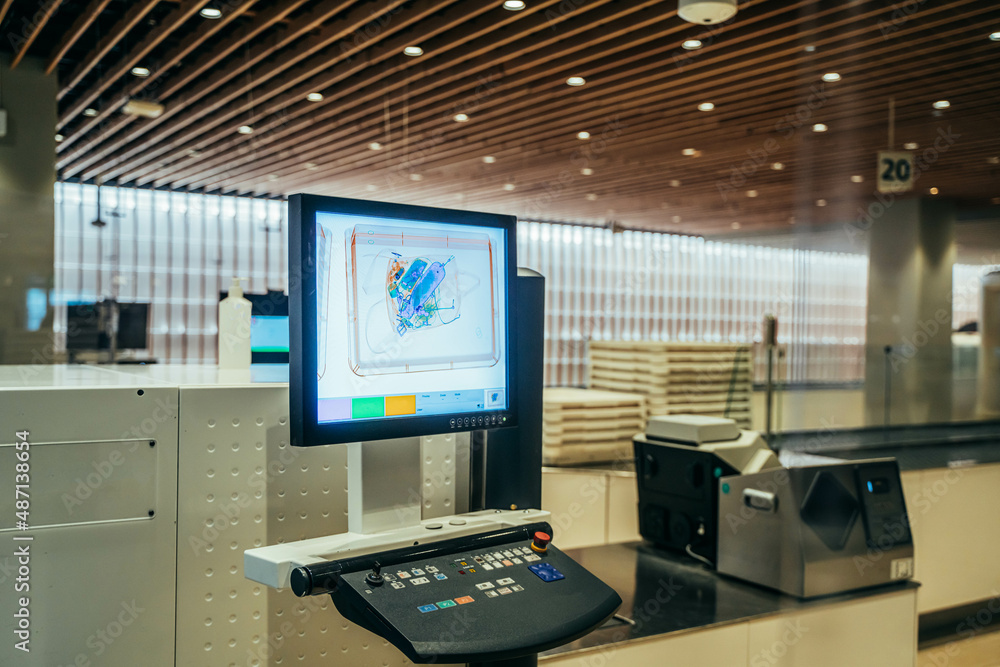 Airport security checkpoint with baggage scanner screen for passengers ...