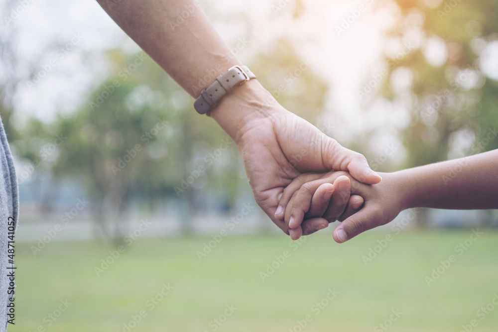 Hand of parent and child in the outdoor .Mother holding hands little ...