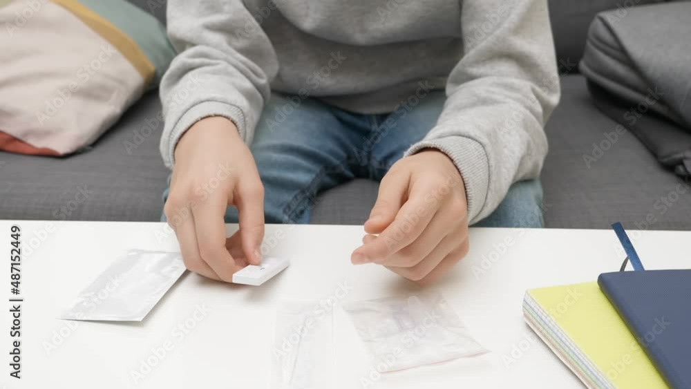 Teenage boy hands unpacking Covid-19 rapid antigen self test kit at ...