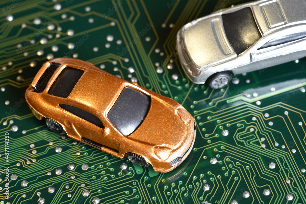 Toy cars on an electronic board with integrated circuits. Conceptual ...