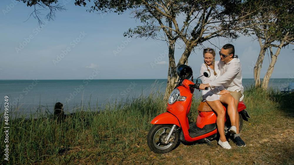 Love couple on red motorbike in white clothes on forest road trail trip ...