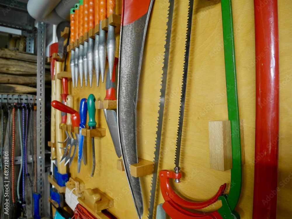 Gardening tools hanging on the wall in a tool shed. Stock Photo | Adobe ...