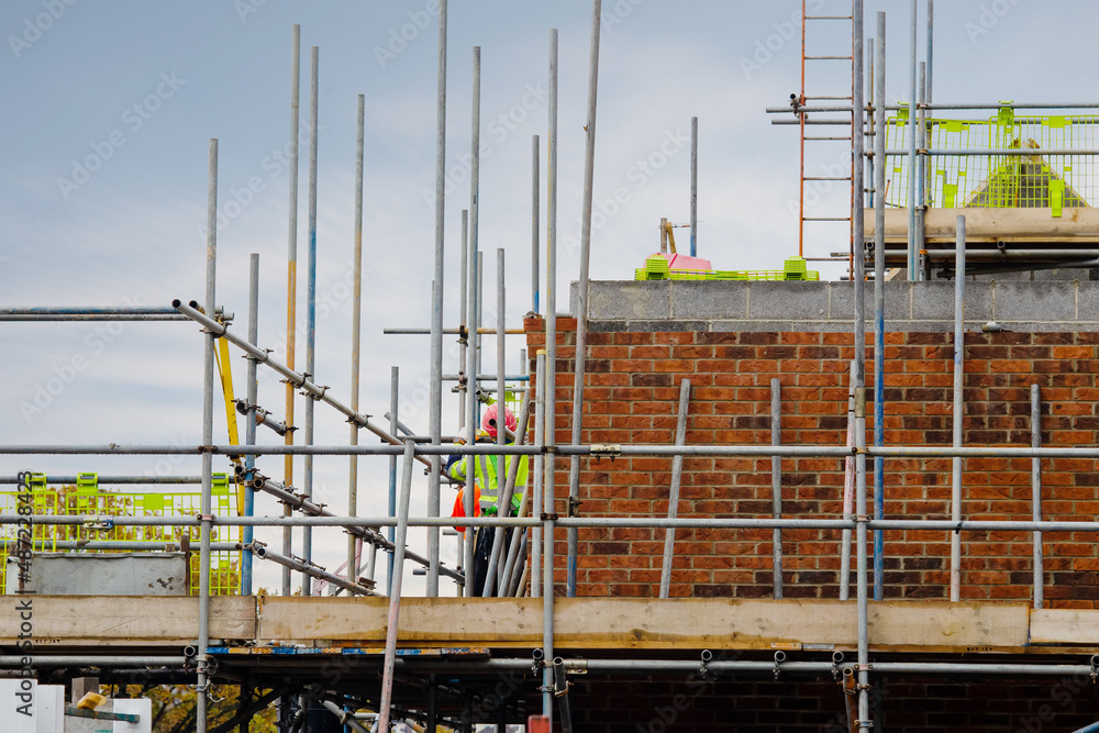 Scaffolder erection scaffolds during new residential house construction ...