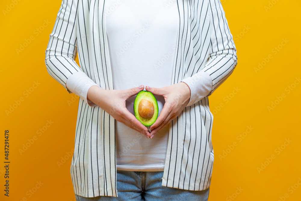 Female Concepts. Caucasian Female Posing With Split Avocado Fruit In ...