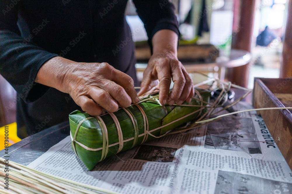 Making Tet cake by old female craftsman closeup. Traditional Vietnamese ...