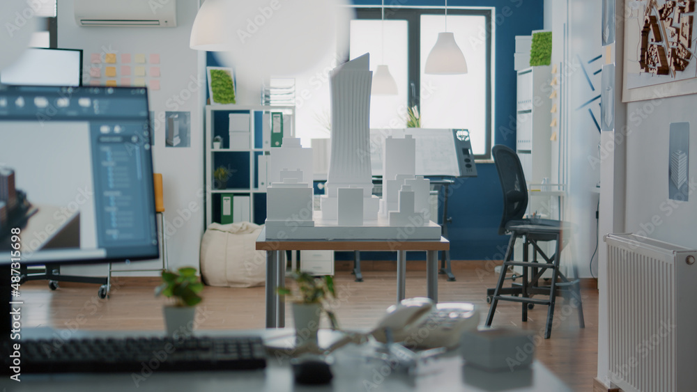 Nobody in office with 3d architecture design and building model for urban project. Empty space ...