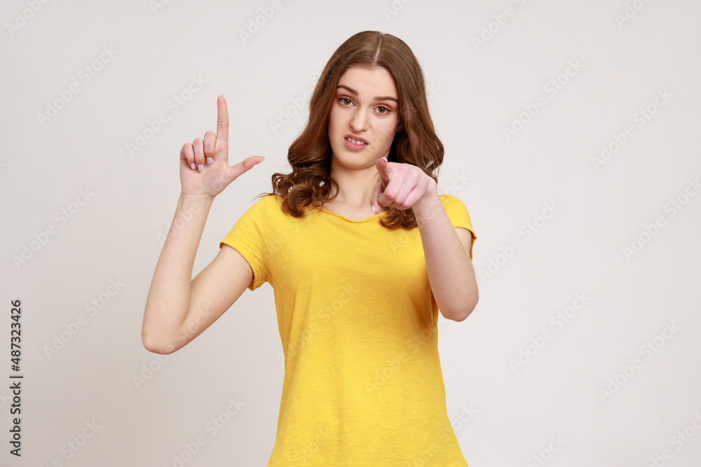 You are loser! Portrait of attractive teen girl with brown hair in ...