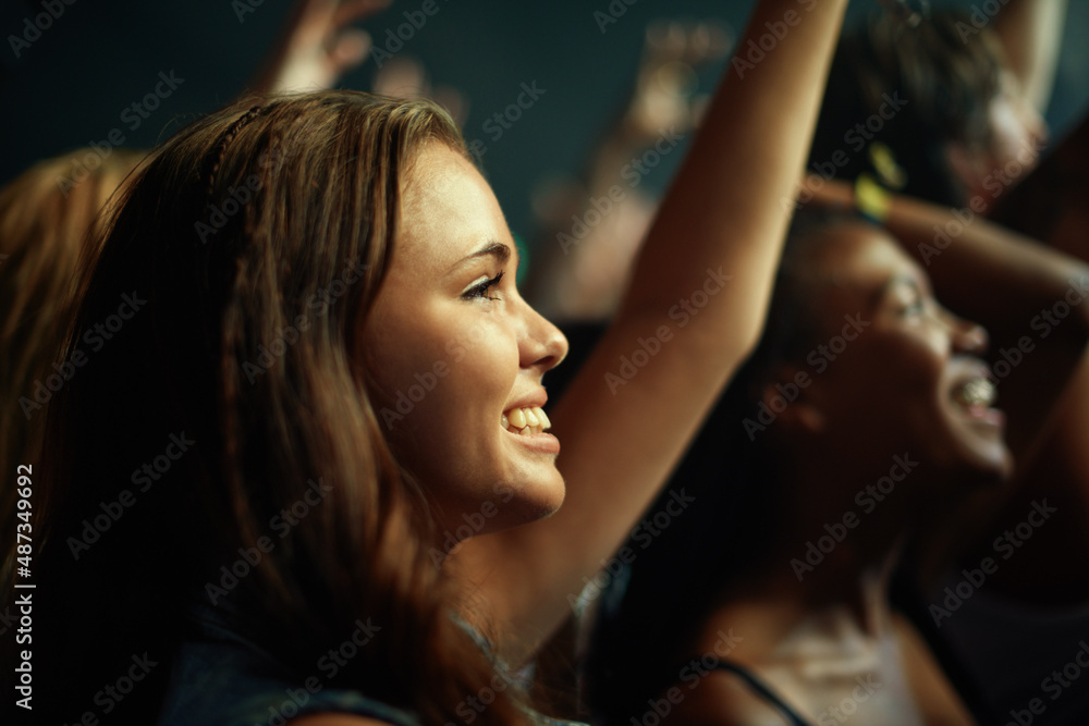 Young girls in an audience enjoying their favorite bands performance ...