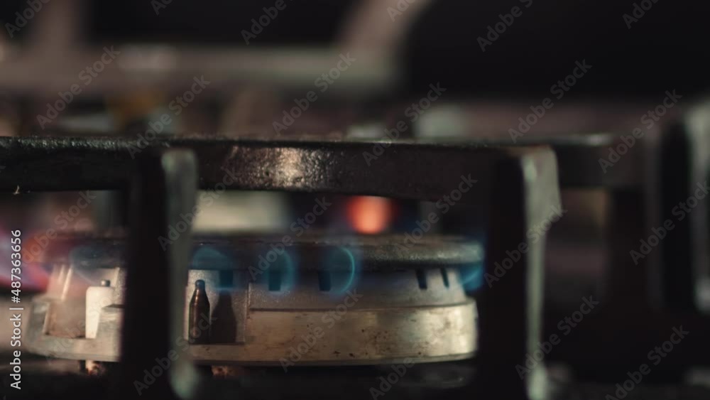 Slow motion of ignition of propane butane gas cooker, sparkles and blue ...