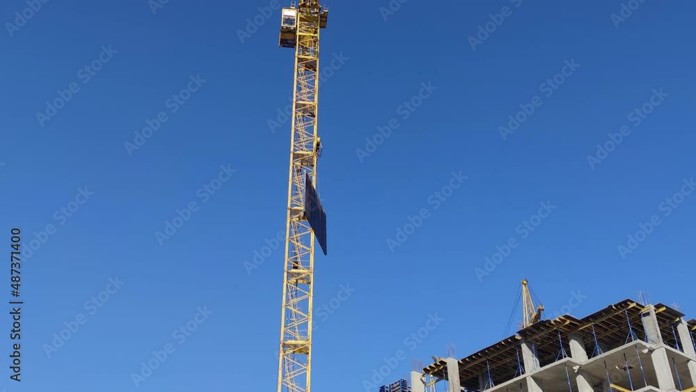 Construction Cranes on the Background of the Blue Sky and the Bright ...