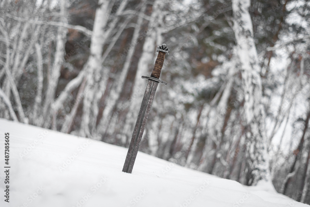 Knight sword in the snow background. The battlefield. Stock Photo ...