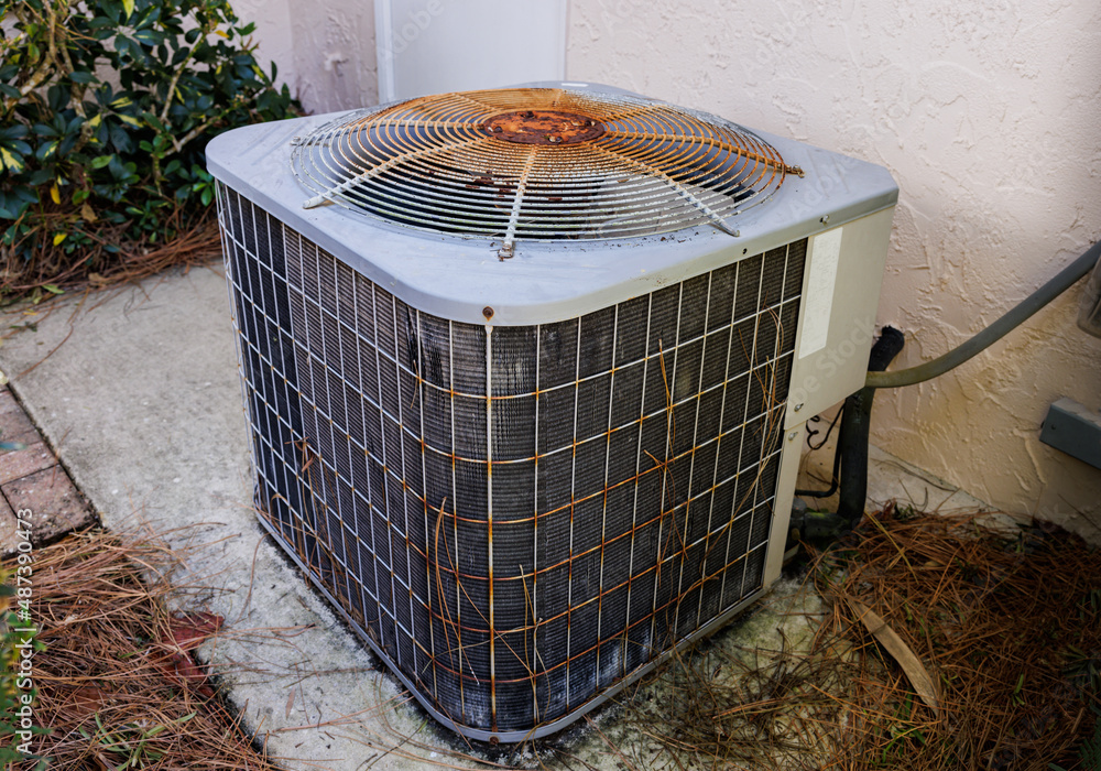 Rusty HVAC air conditioner in need of repair. Old AC unit on concrete ...