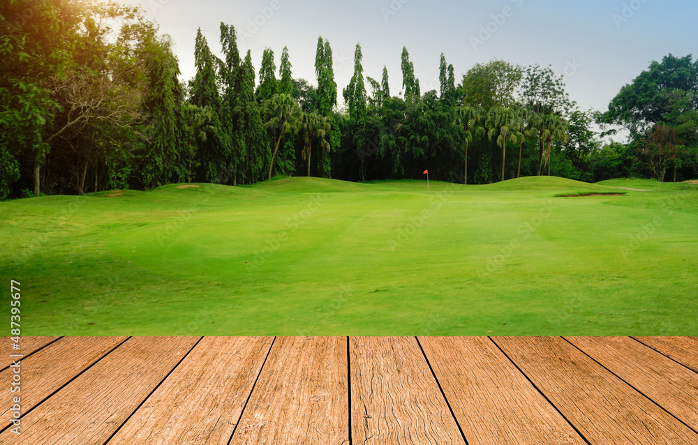 Wooden floor and golf course background. Fresh spring green golf course ...