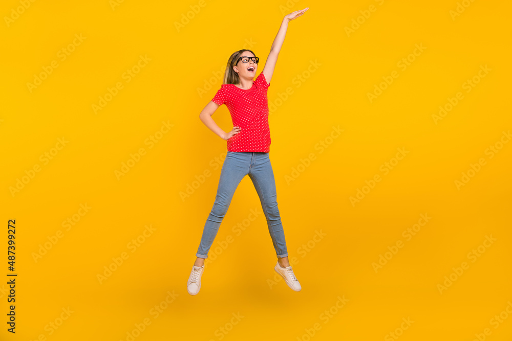 Full size photo of young pretty girl energetic jump demonstrate arm ...