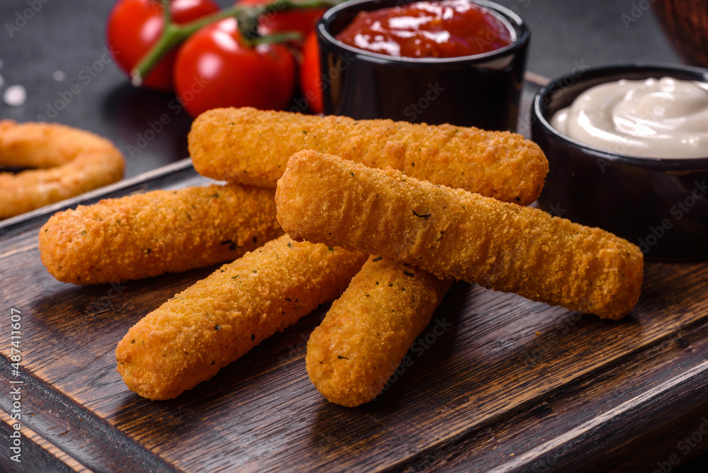 Breaded mozzarella cheese sticks served with tomato sauce Stock Photo ...