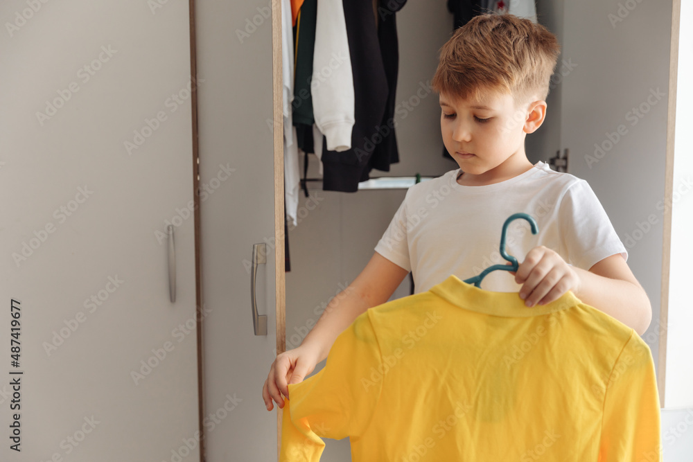 Tween boy getting ready for school in the morning. Cute little boy open ...
