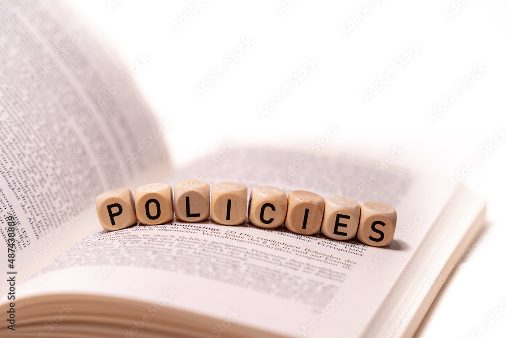 the word POLICIES spelled on an open book with wooden letters, concept ...