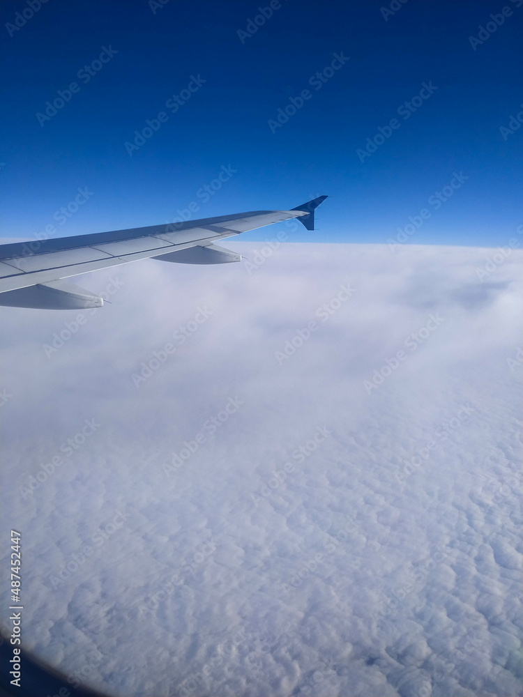 The view from the plane window on a cloudy sky in winter. Cabin window ...