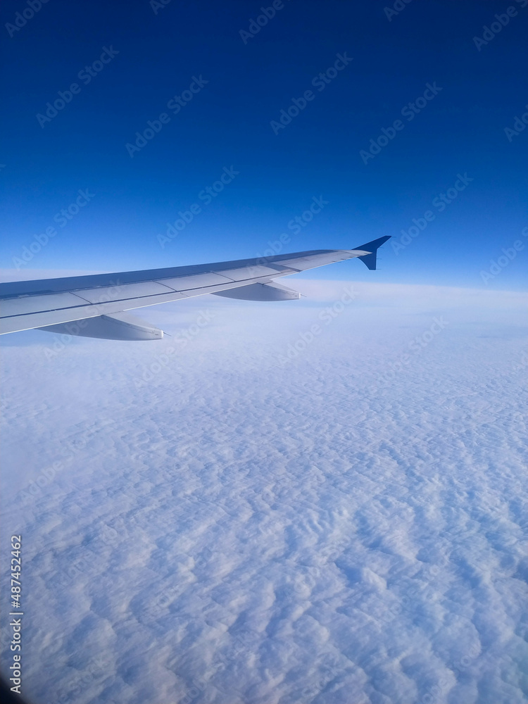 The view from the plane window on a cloudy sky in winter. Cabin window ...