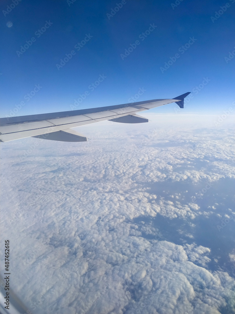 The view from the plane window on a cloudy sky in winter. Cabin window ...