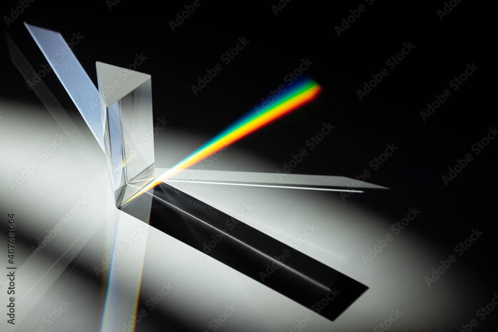 Triangular Prism dispersing sun beam splitting into a spectrum on white ...