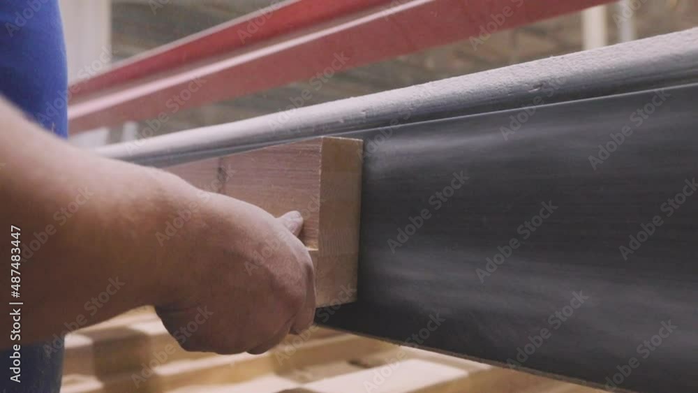 Furniture manufacturing process. Wood furniture sanding. A worker is ...