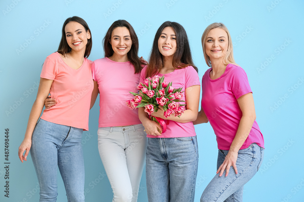 Beautiful women with bouquet of flowers on blue background ...