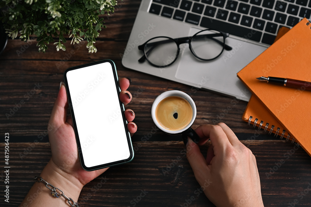 Stylish man hands holding smart phone with white screen and coffee cup ...