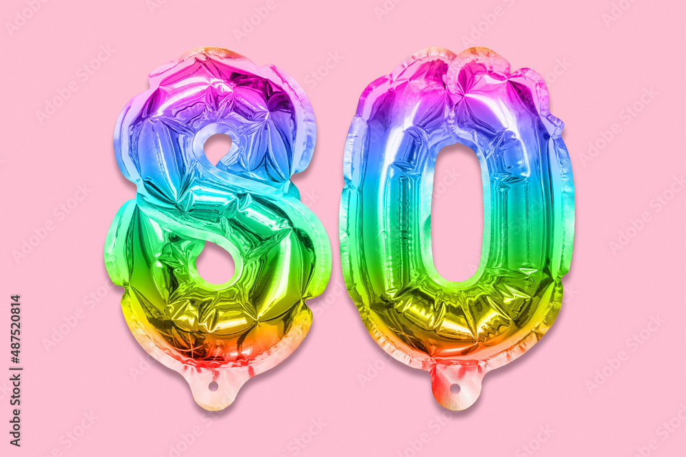 Rainbow foil balloon number, digit eighty on a pink background ...