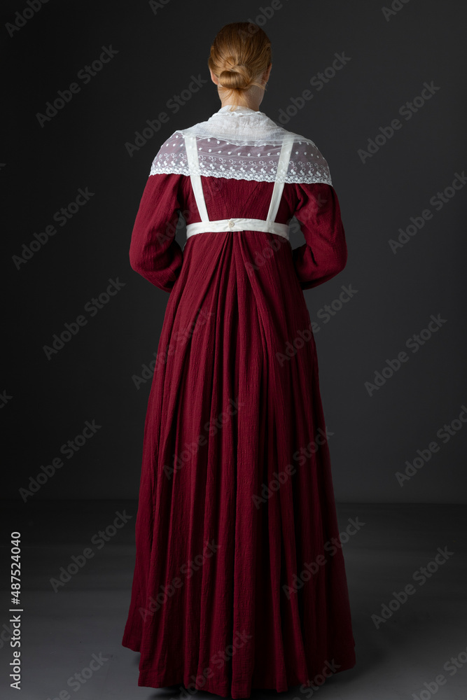 A Regency maid servant or working woman wearing a red linen dress with ...