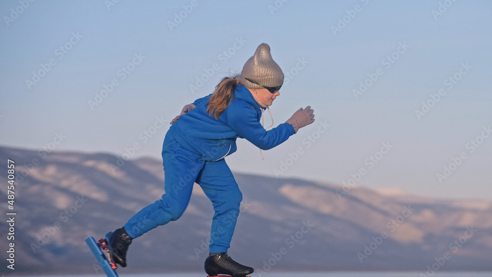The child train on ice professional speed skating. The girl skates in ...