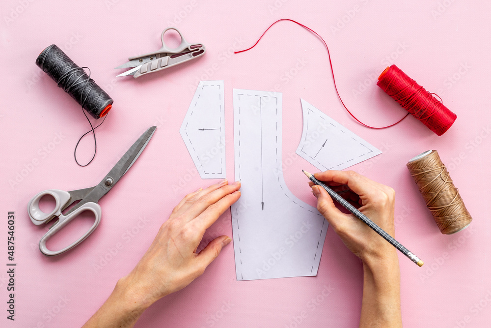 Female hands holding sewing patterns. Sewing background for dress ...