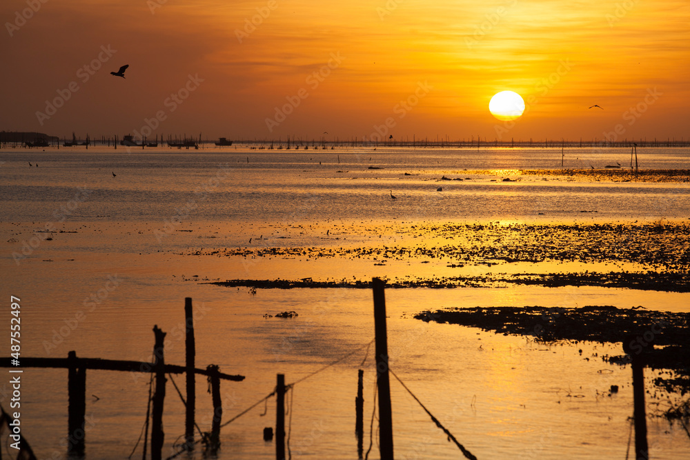 Beautiful landscape of sea level reflect fantasy dramatic sunset sky in ...