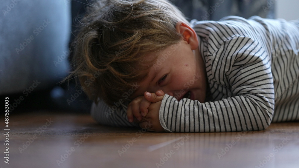 Child crying on floor having tantrum little boy cries Stock Photo ...