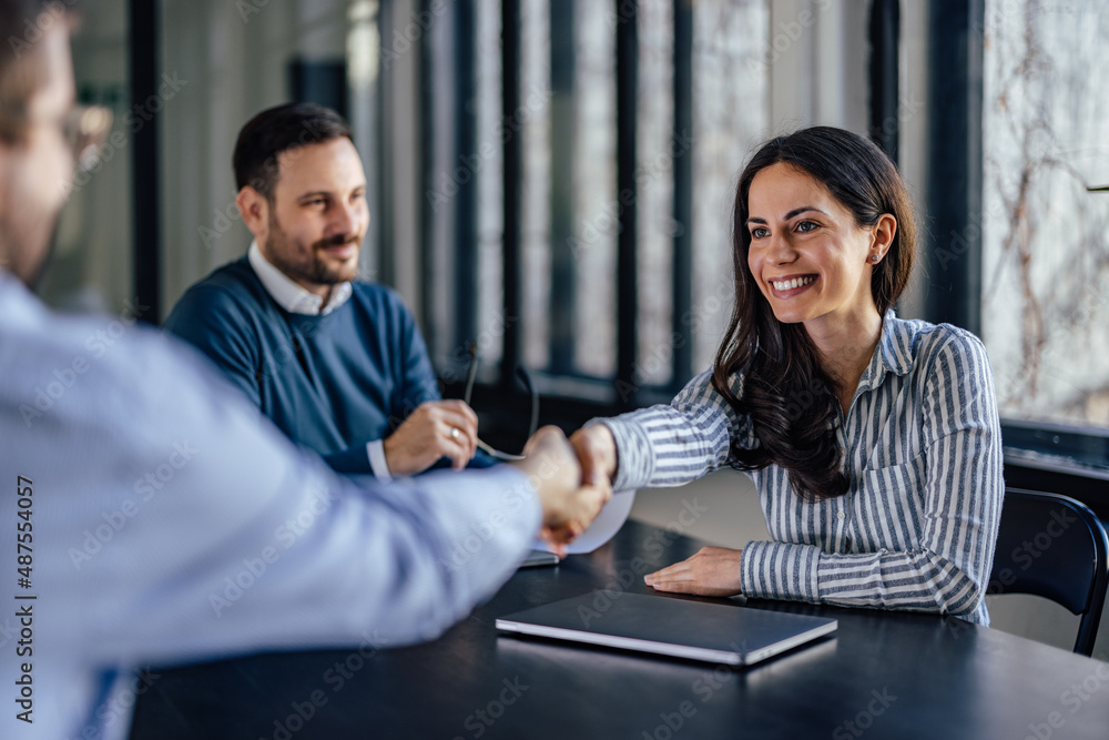 Lovely caucasian woman, saying goodbye to her clients after a meeting ...